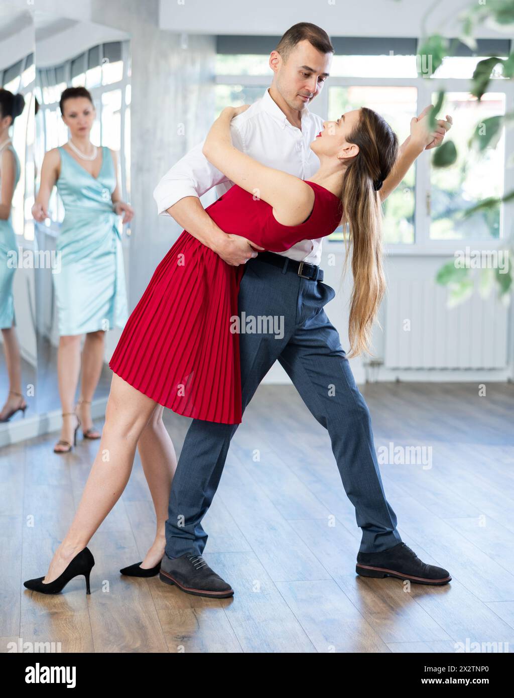 Couple in stage costumes learns waltz dancing during individual lesson ...