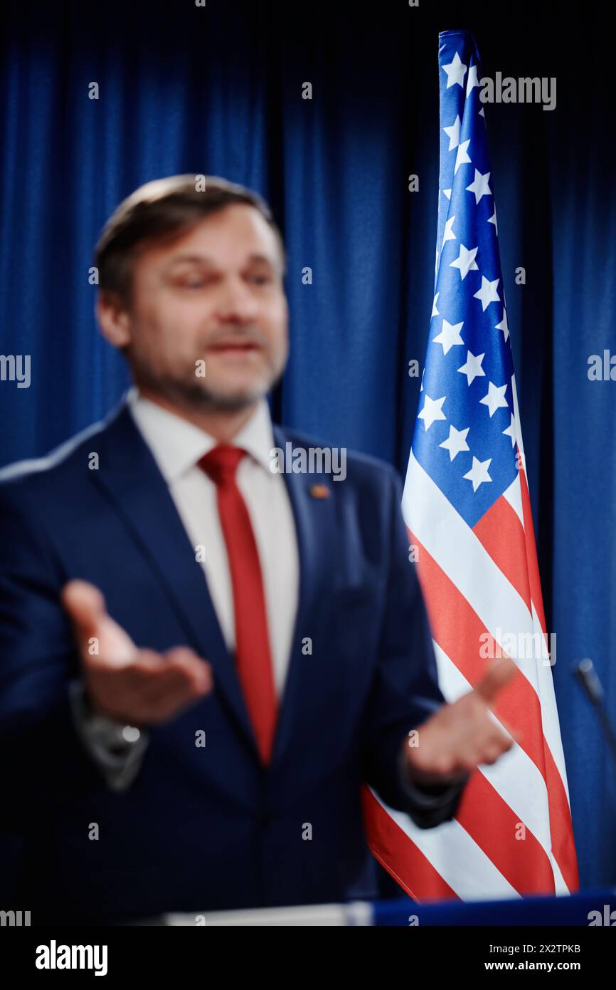 American flag behind speaker hi-res stock photography and images - Alamy