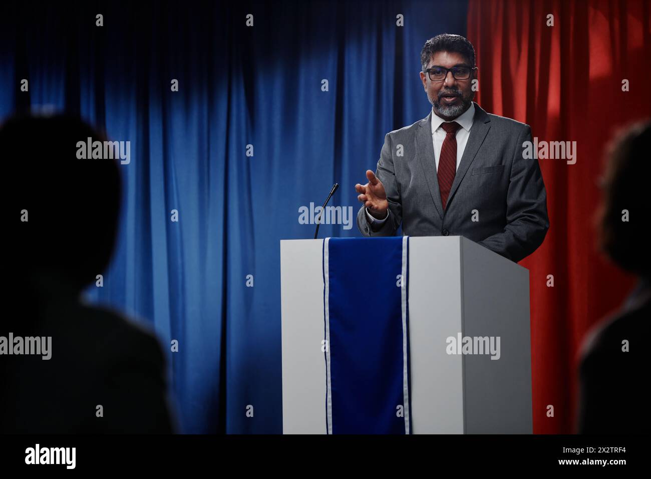 Mature multiethnic male politician in formalwear looking at public at ...