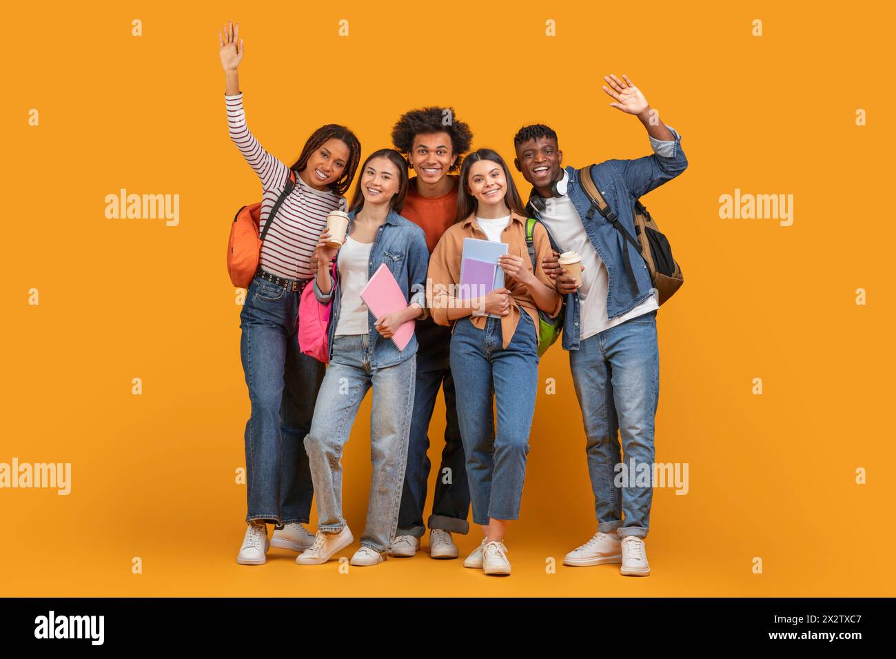 Happy students waving goodbye or greeting on orange background Stock ...