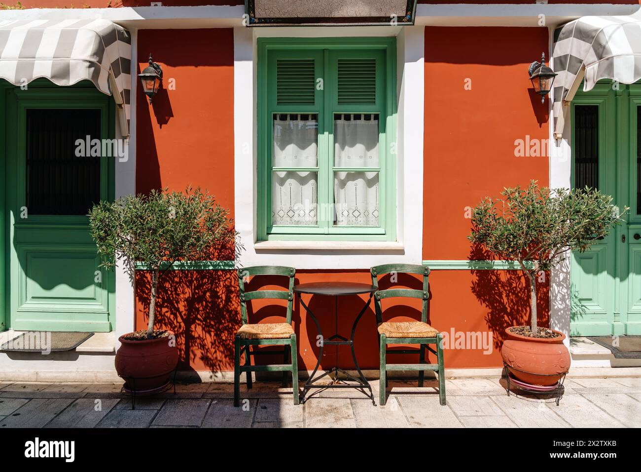 Quaint European street cafe with green accents and plants Stock Photo ...
