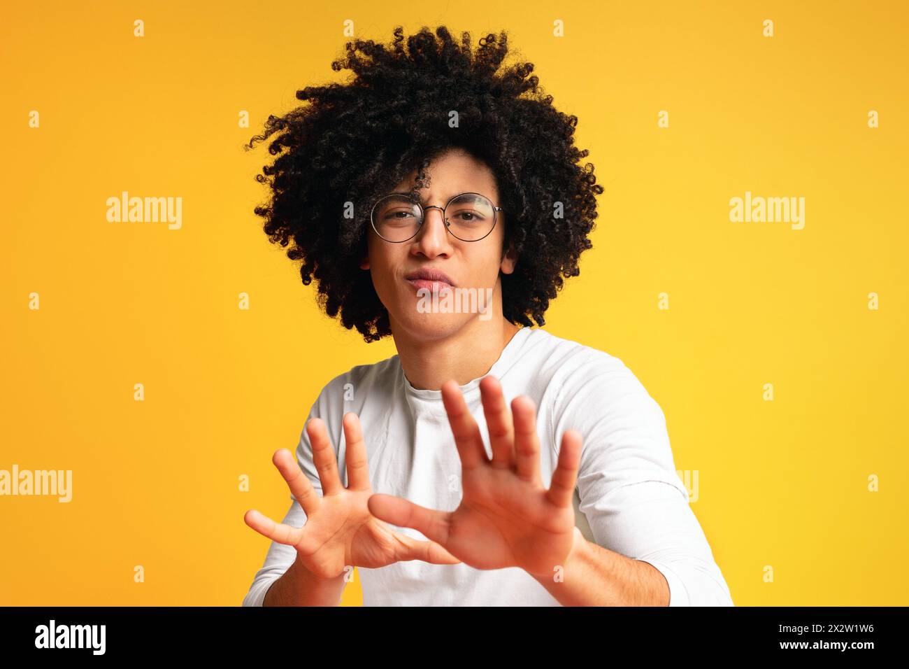 Cute black man waving hands like magician Stock Photo - Alamy