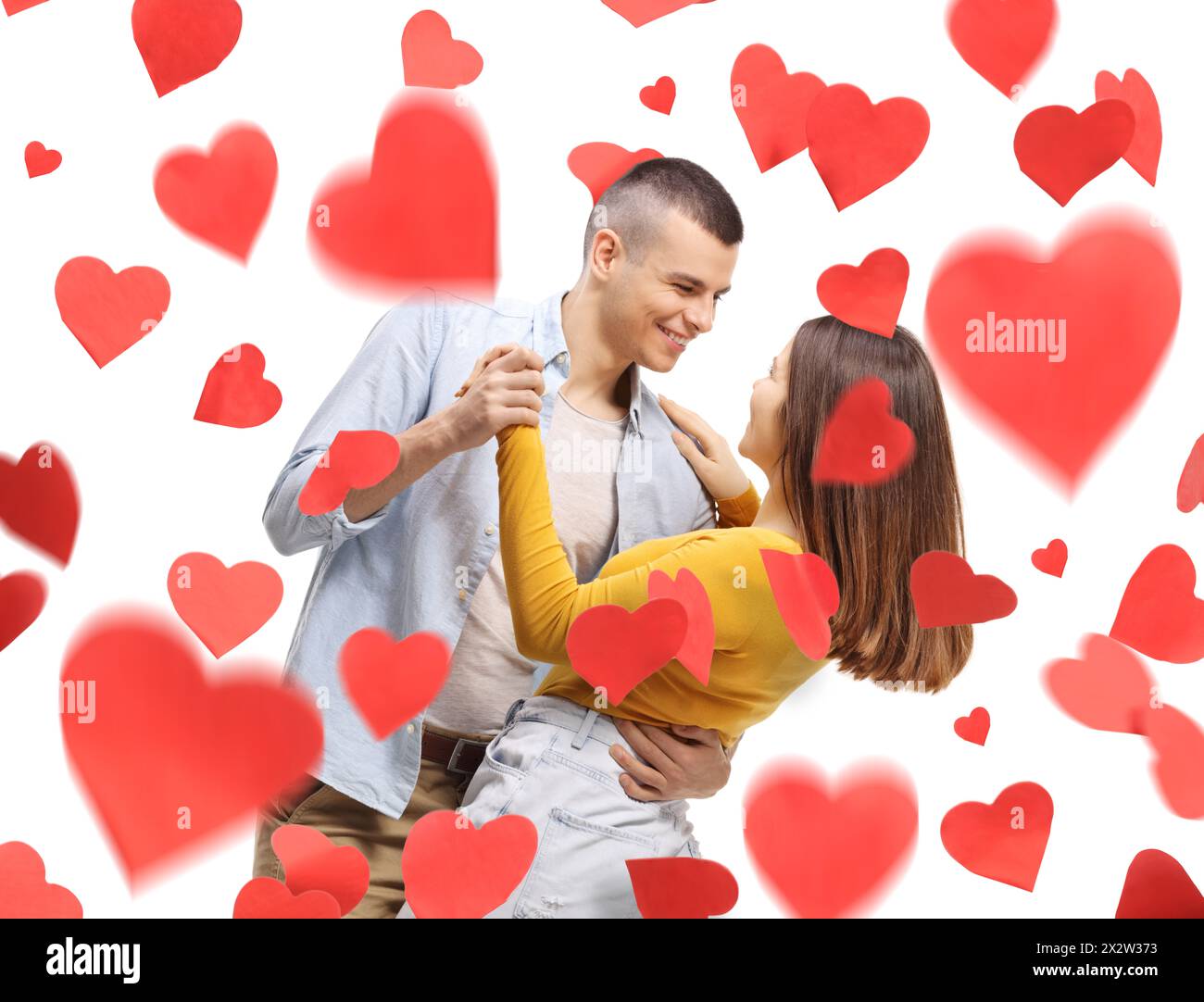 Young couple dancing tango under red heart confetti isolated on white ...