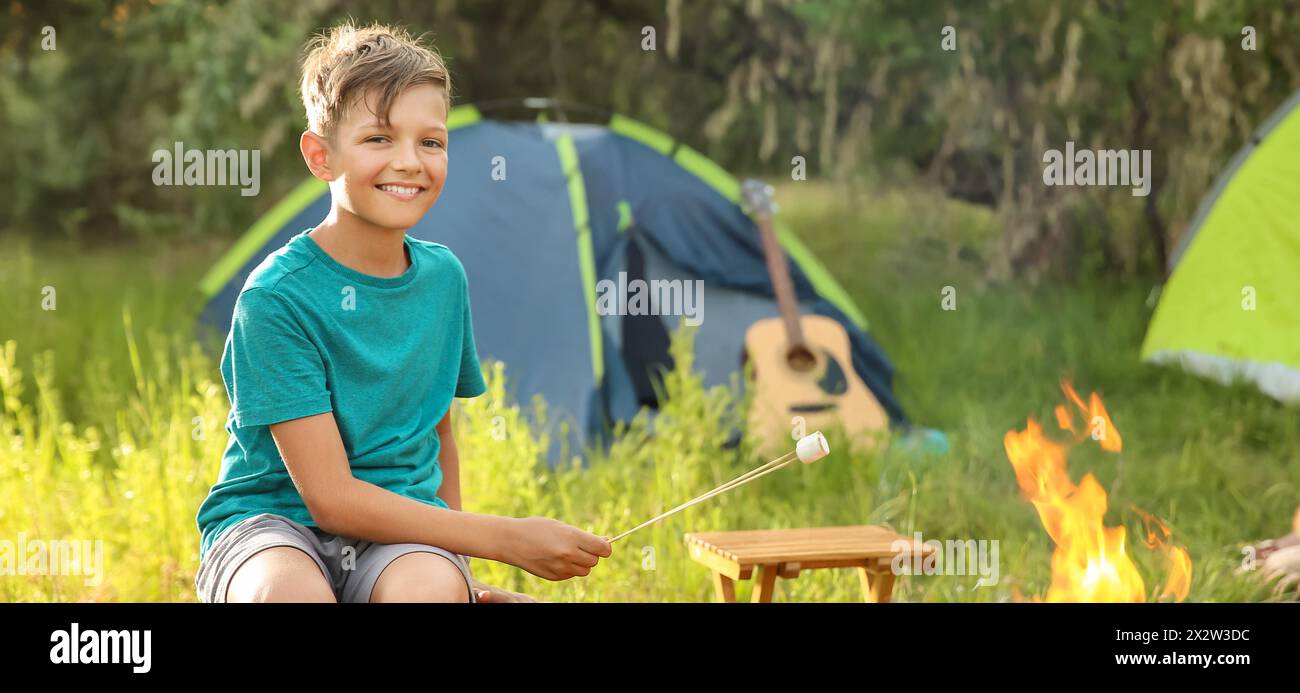 Boy roasting marshmallow on fire at summer camp Stock Photo - Alamy