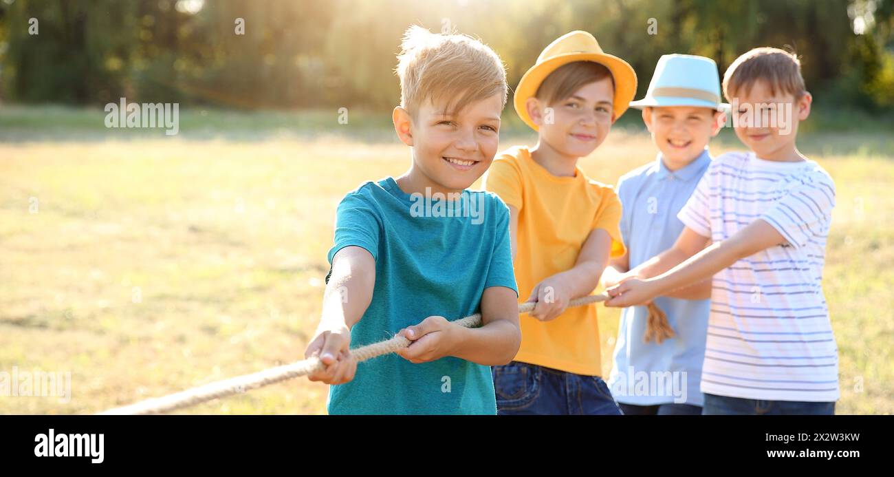 Group of boys pulling rope at summer camp Stock Photo - Alamy