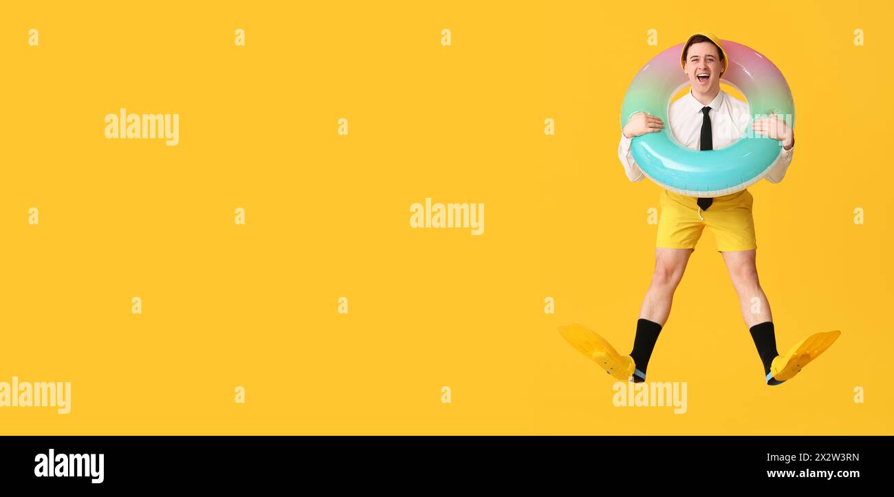 Office worker with inflatable ring and flippers jumping on yellow ...