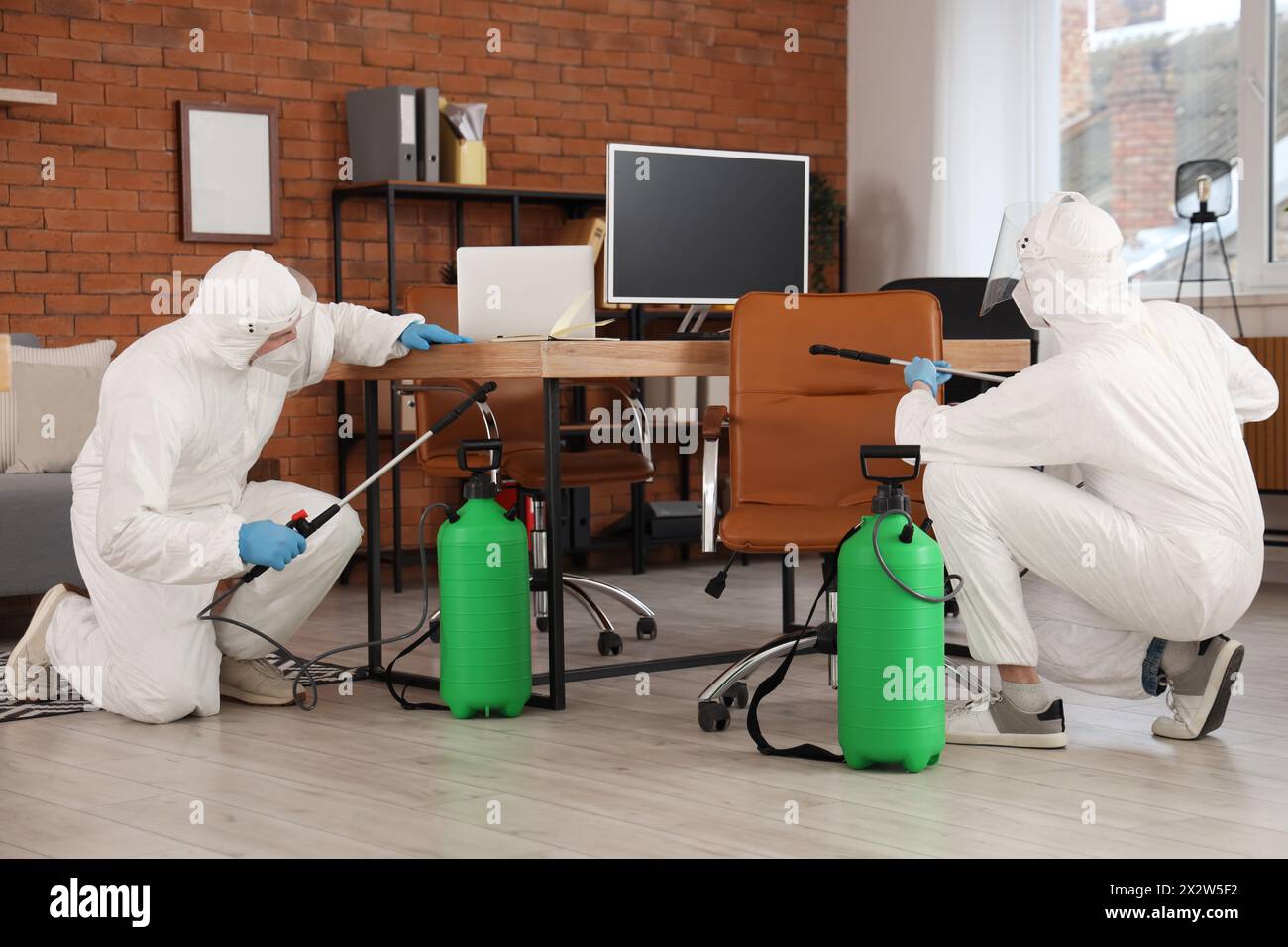 Professional workers disinfecting in office Stock Photo - Alamy