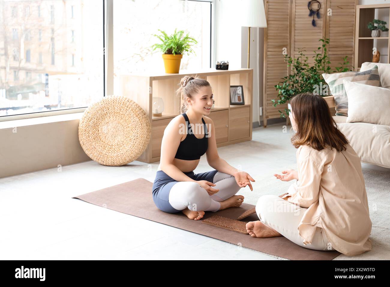 Young women with Sadhu board meditating at home Stock Photo - Alamy