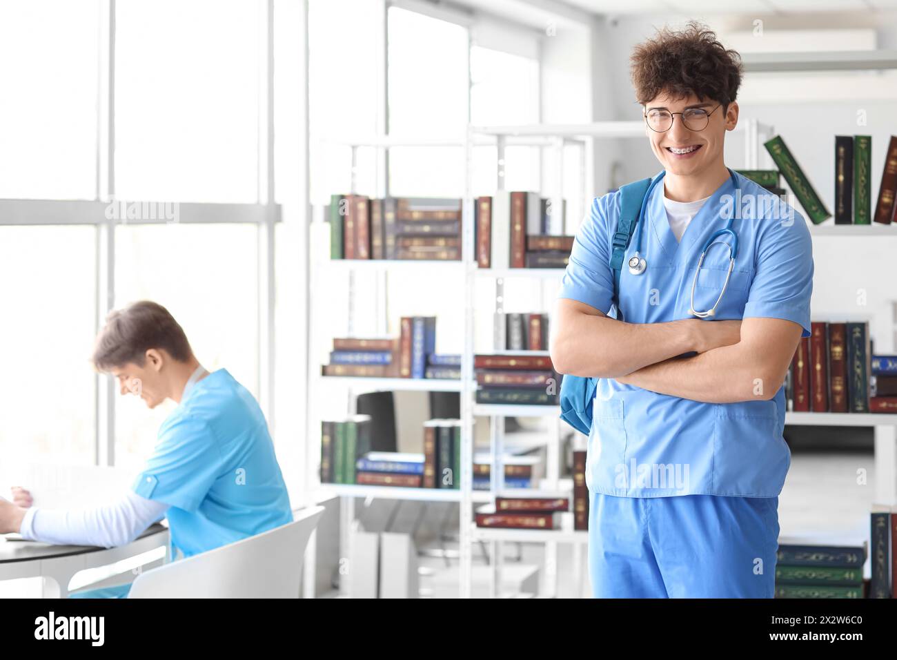 Male medical intern with backpack in library Stock Photo - Alamy