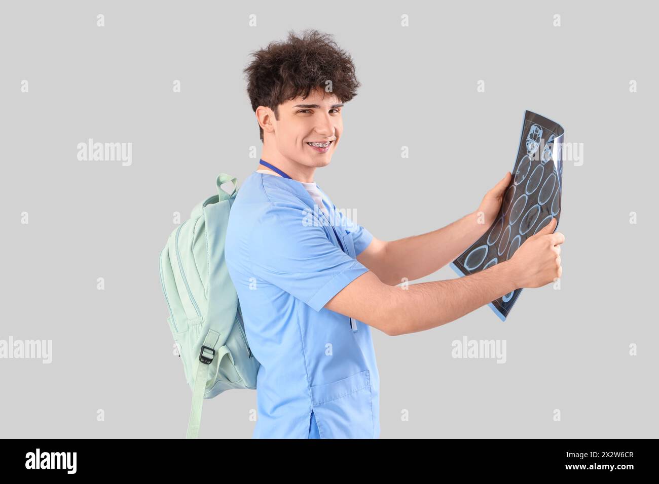 Male medical intern with MRI scan on light background Stock Photo - Alamy