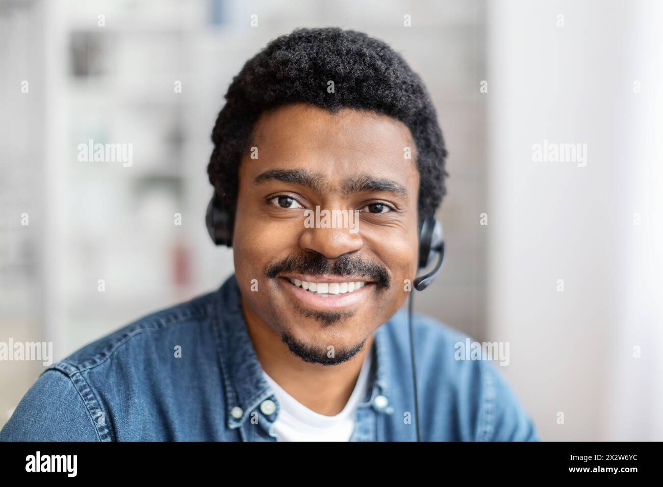 Friendly black guy with headset smiling at camera Stock Photo - Alamy