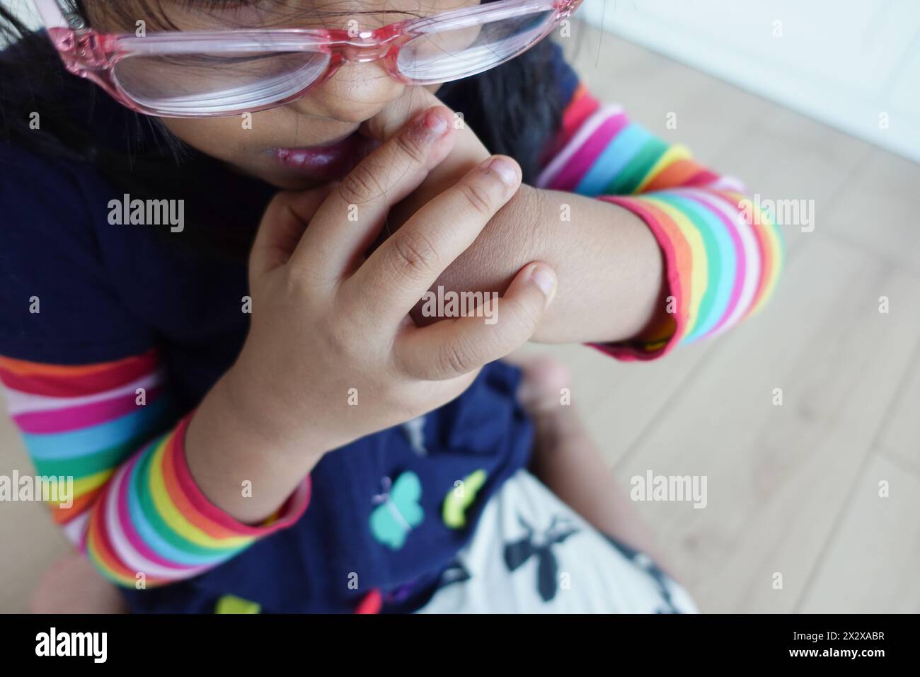 child girl biting her nails at home Stock Photo - Alamy