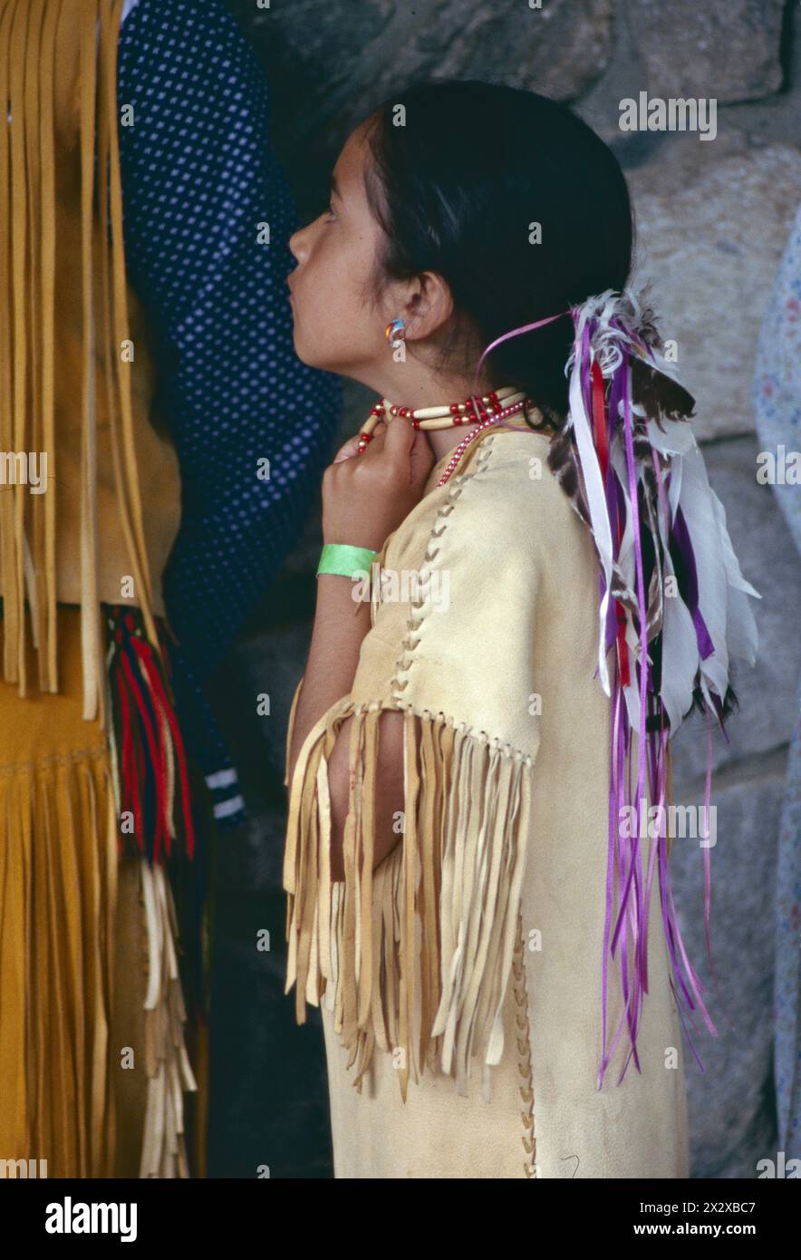 A young, indigenous Cherokee girl attends a festival in traditional ...