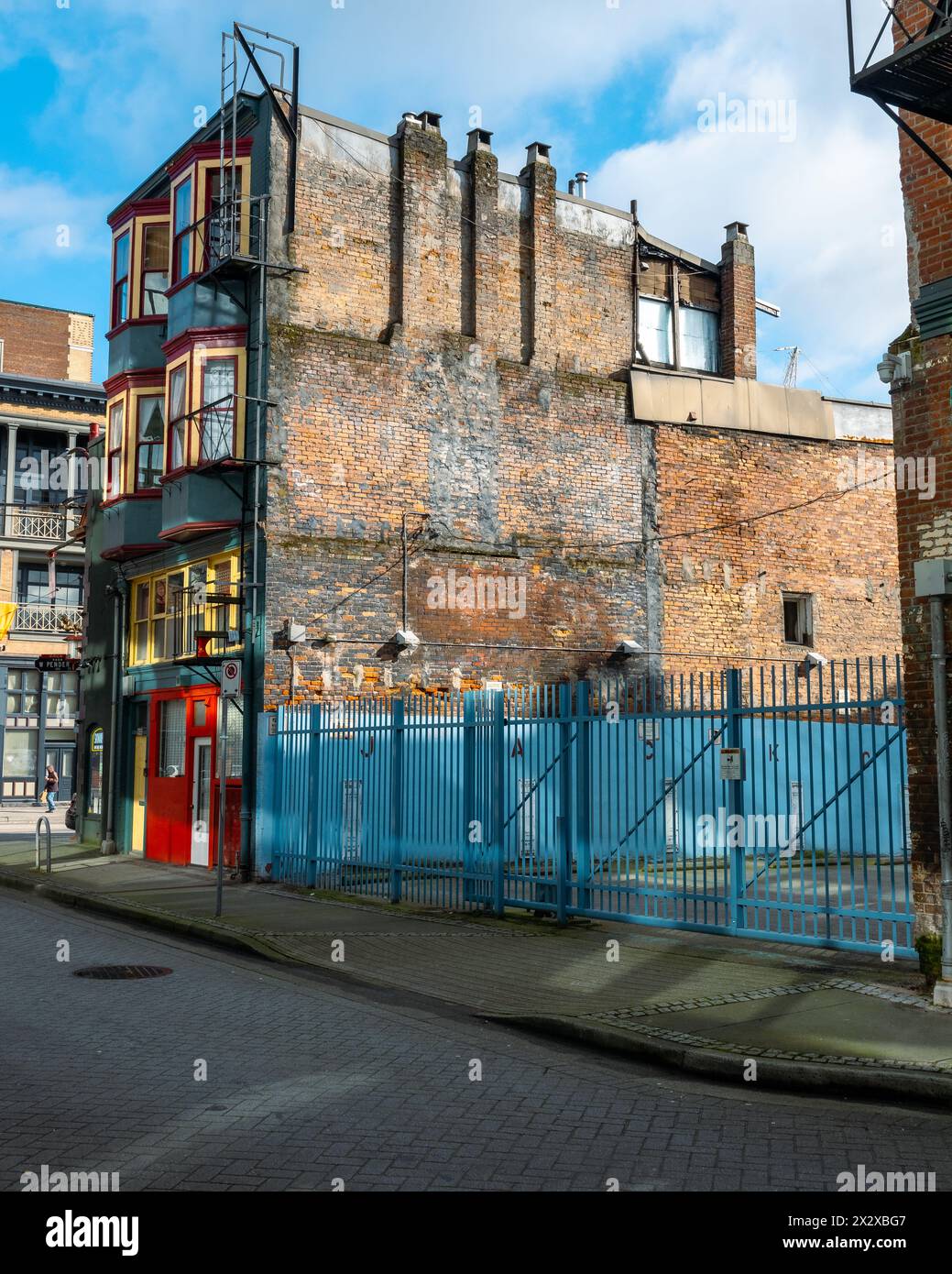 A view of the side of an old heritage brick building with bay windows ...