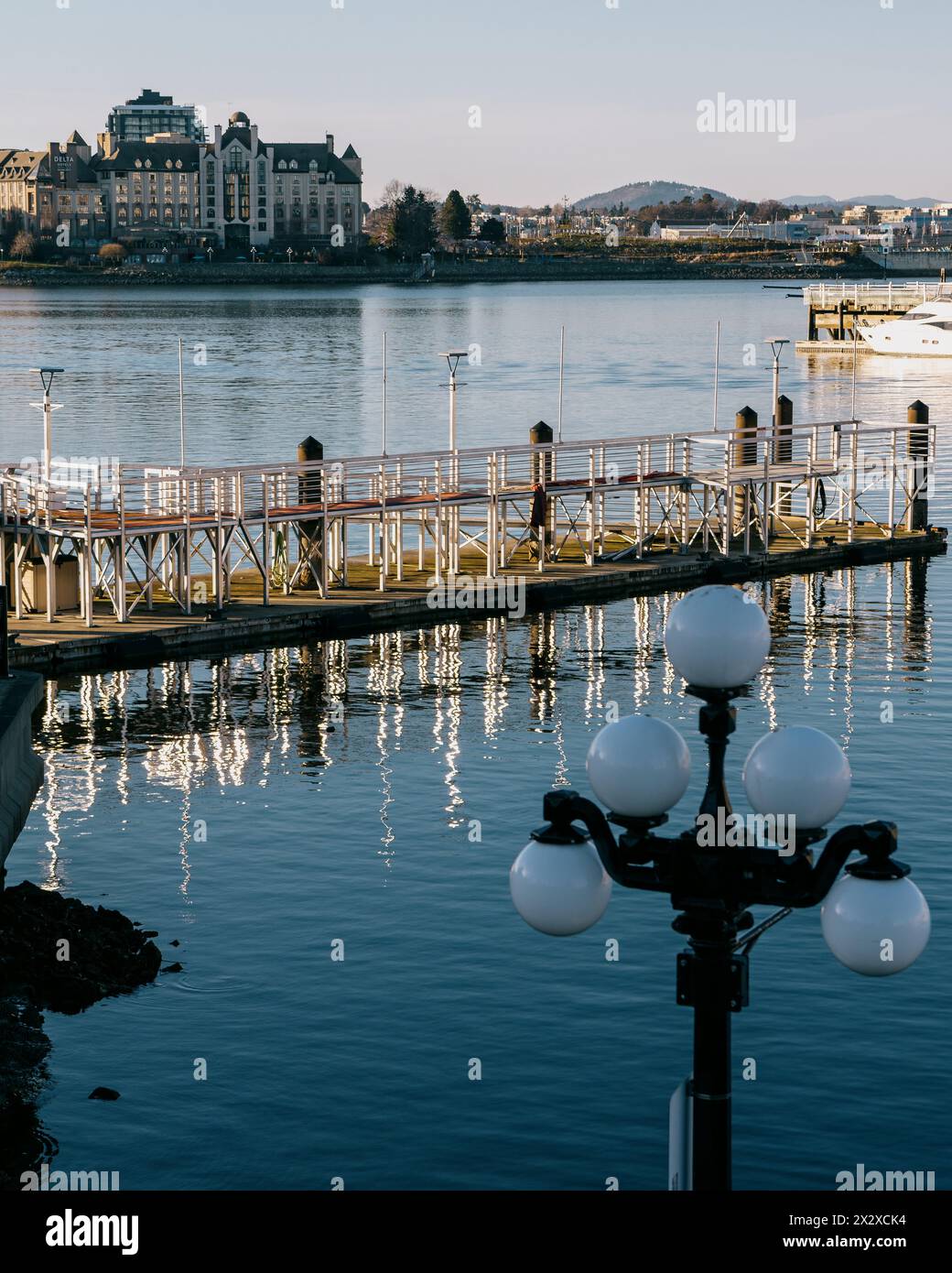 A floating dock in the harbor, with the water reflecting its sunlit ...
