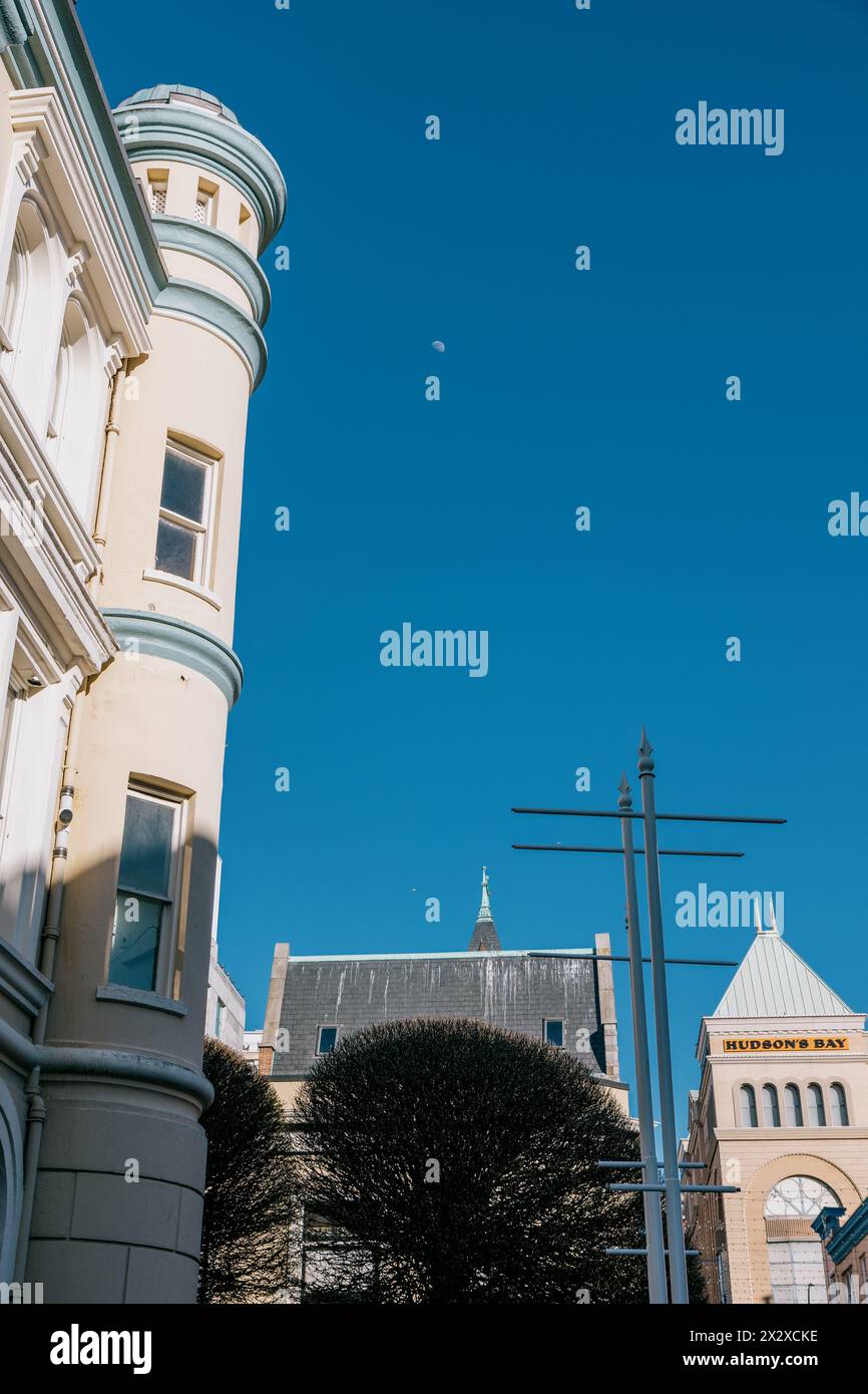 Victoria, Canada - Mar 18 2024: A half moon in the clear deep blue sky ...
