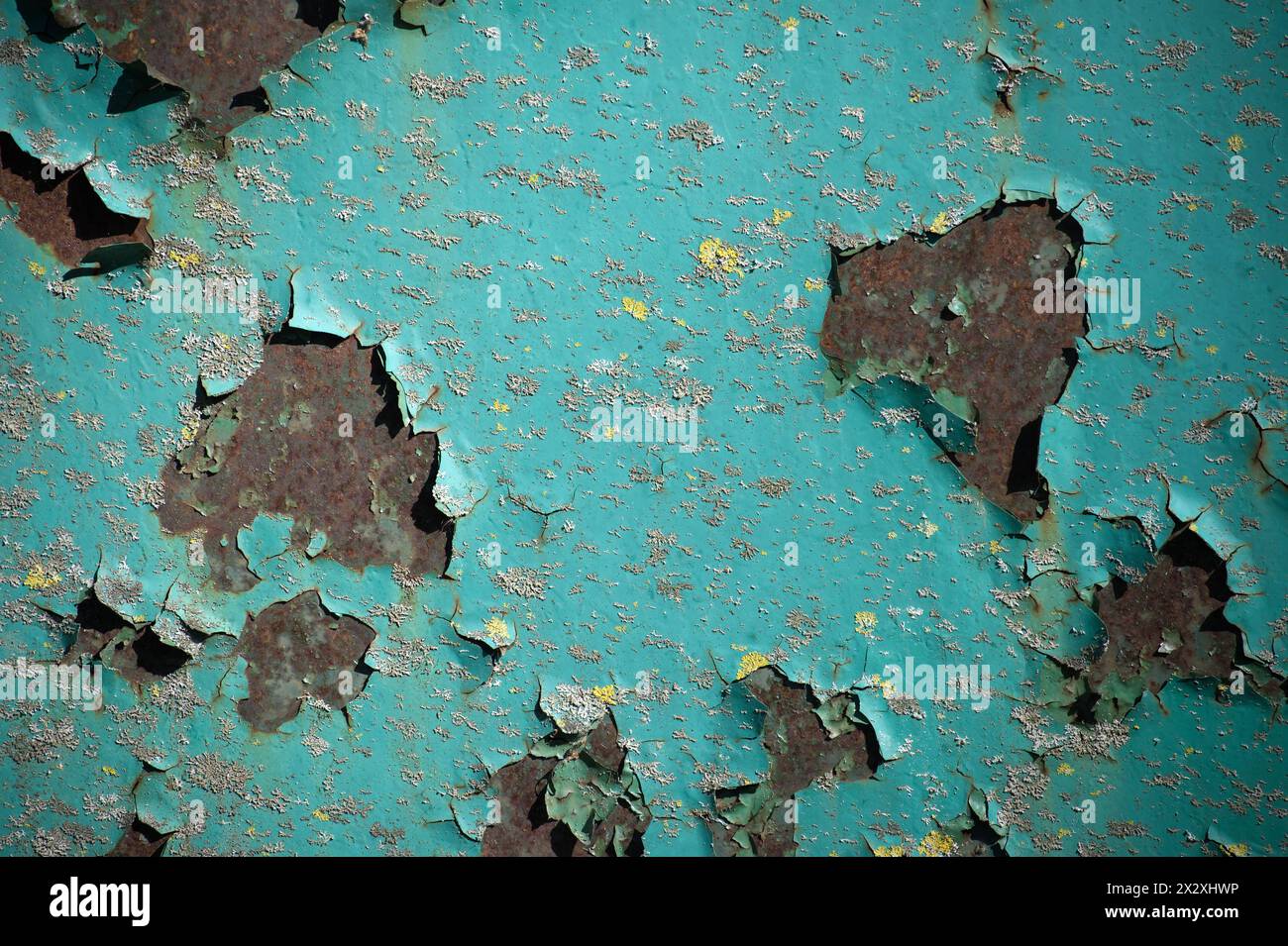 Turquoise paint chips and peels away, it reveals the darker rusted ...