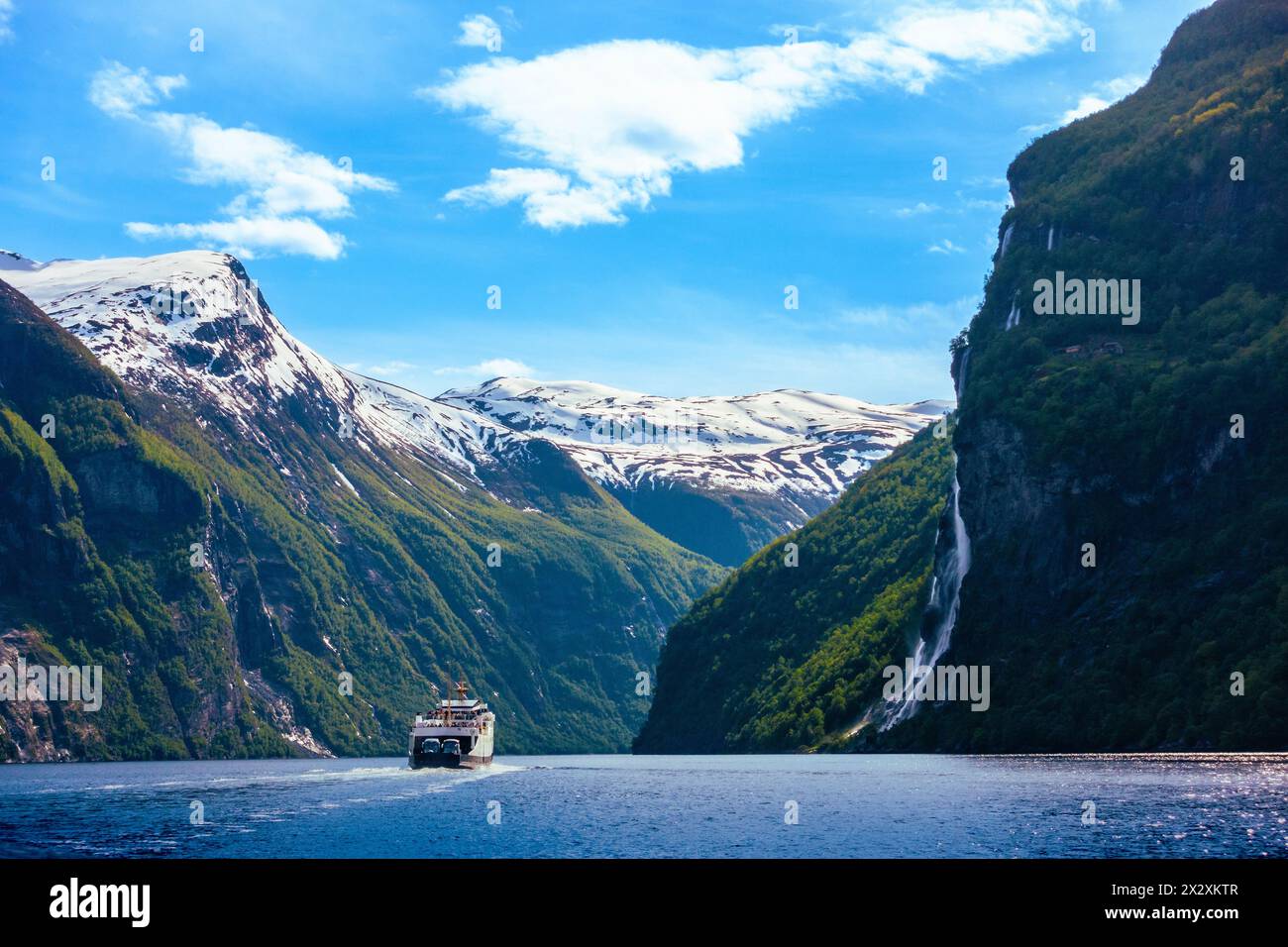 Boating the massive snow capped mountains and lush cliffs lined with ...