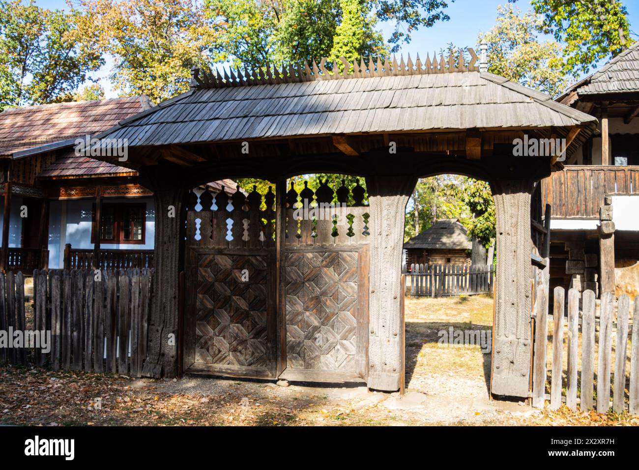 Traditional wooden gate and house at the Dimitrie Gusti Village Museum ...