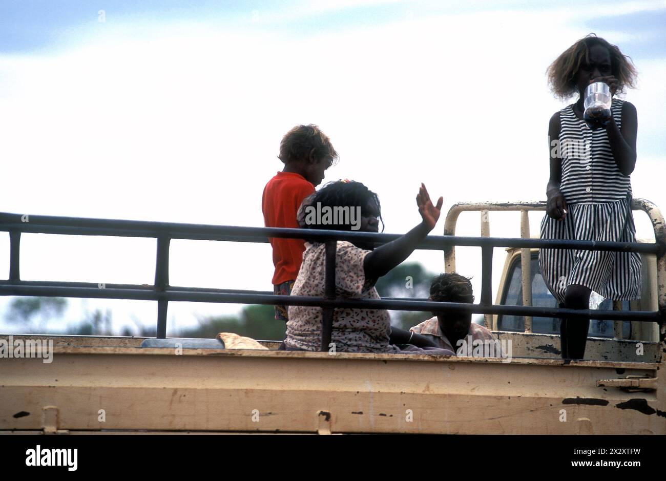 Aboriginal family riding on the back of a pick up, Wiluna, Western ...