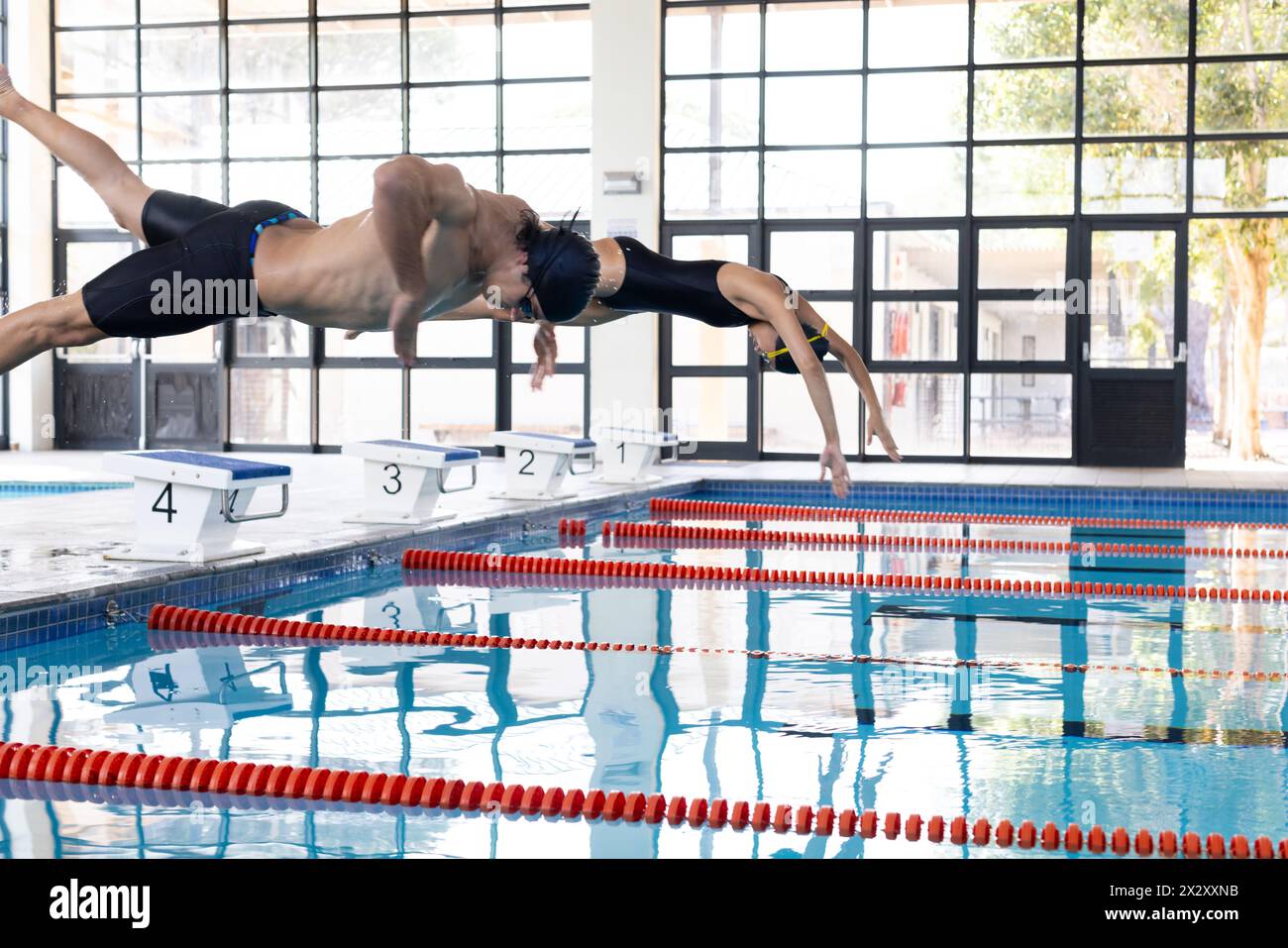 Diverse young swimmer competitors, including a Caucasian male and ...