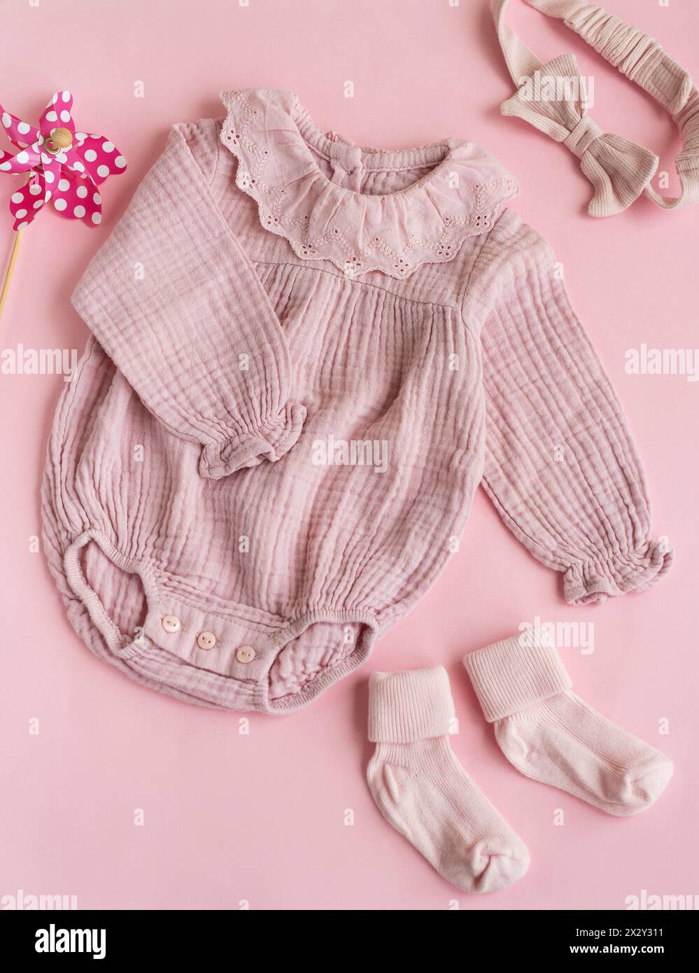 Set of pink clothes and accessories for newborn baby. Baby shower concept. Flat lay, top view ...