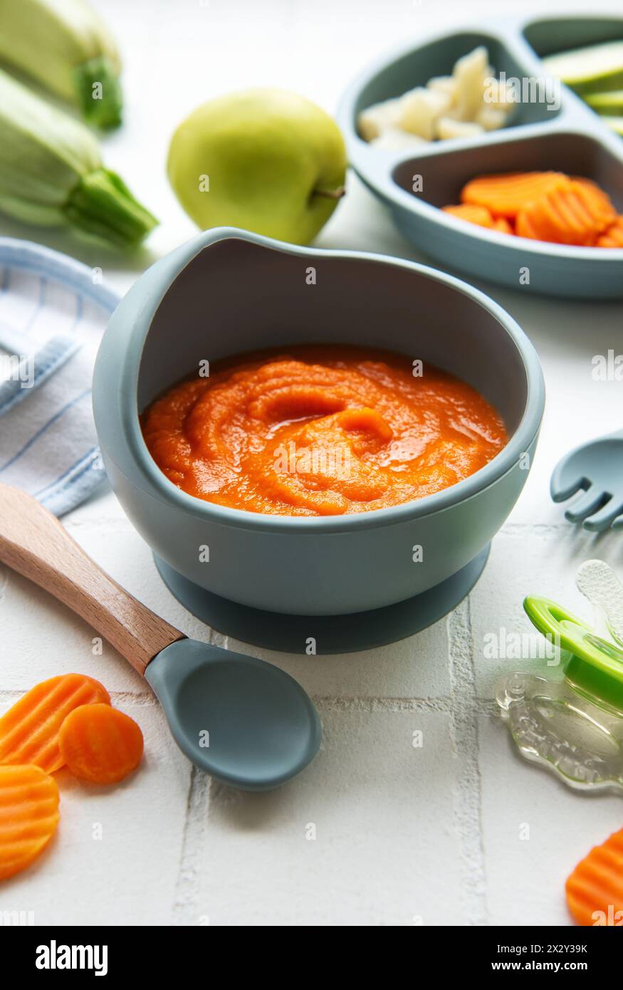 Healthy baby food in bowl. Baby food vegetable puree with carrot Stock ...