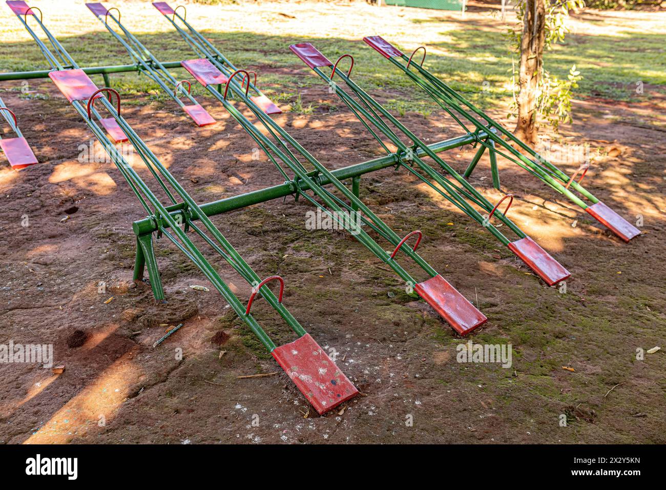 green and red metal seesaw in park playground Stock Photo - Alamy