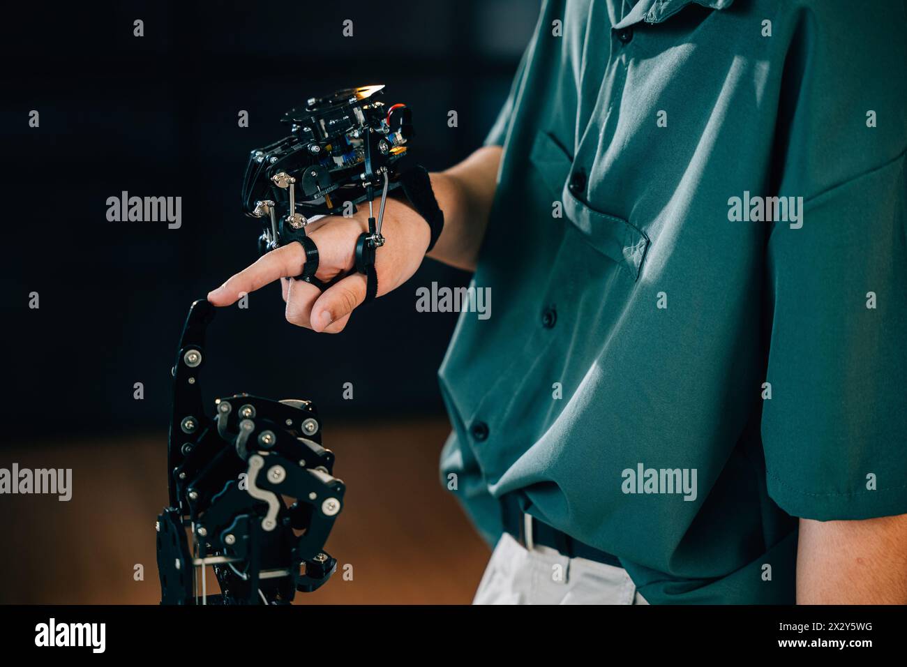 Teenage boy in a technical college learns technology testing a robot ...
