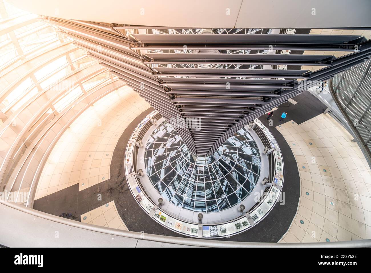 The intricate metal spiral ramp leading upwards inside the modern glass ...