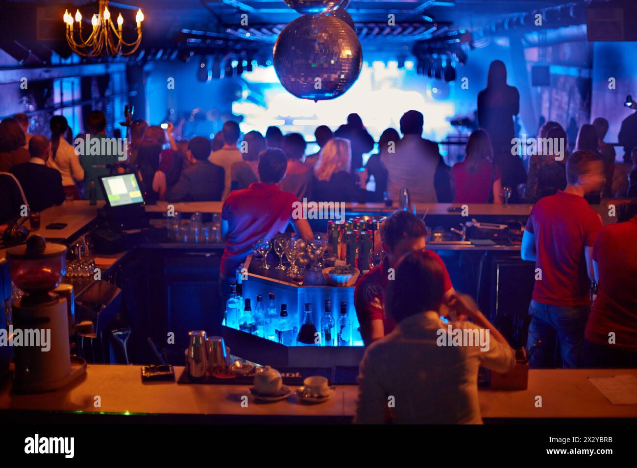 People in bar look at musical show, rear view from bar counter Stock ...