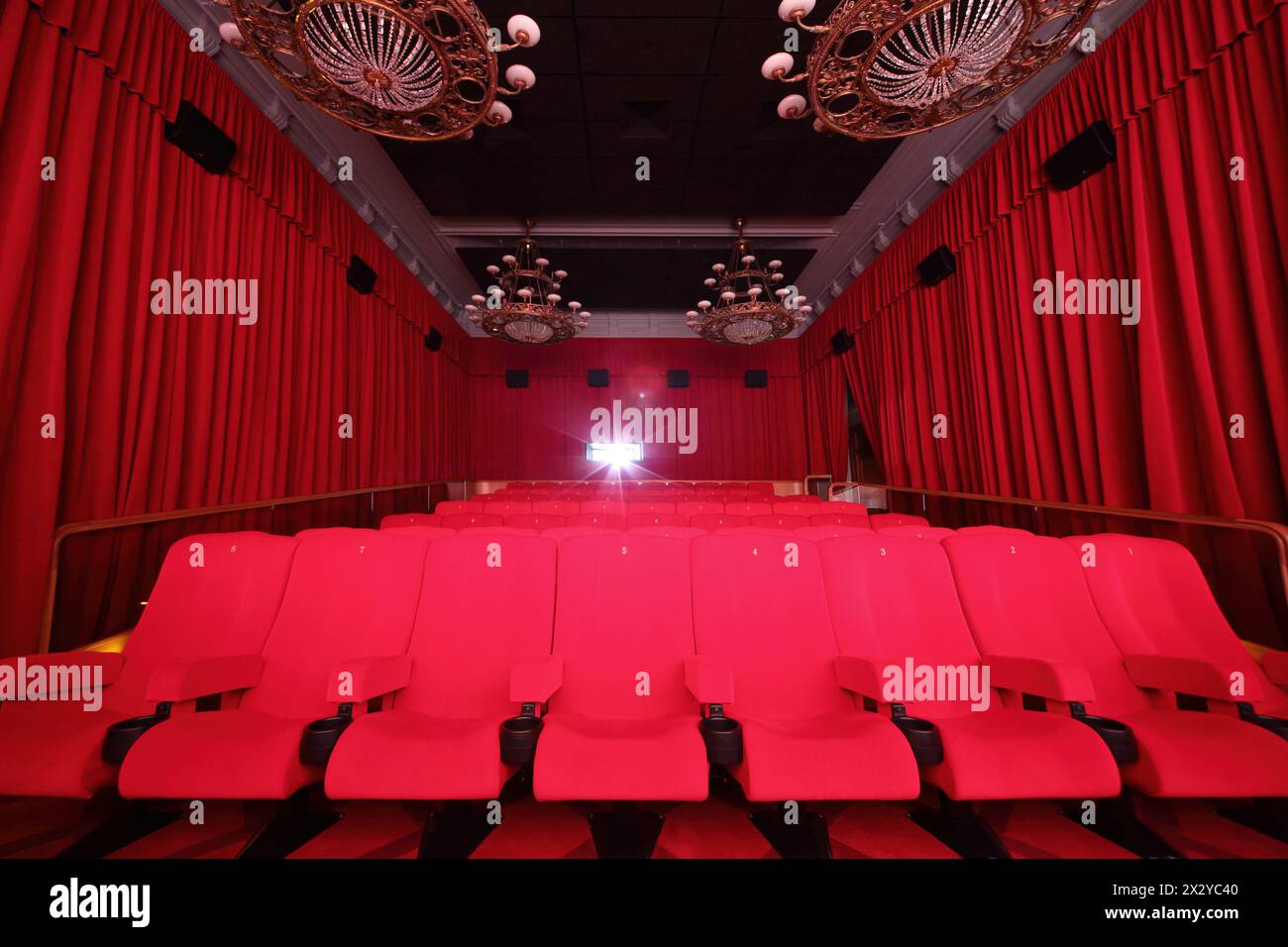 Small hall in cinema theater with red curtains and big beautiful ...