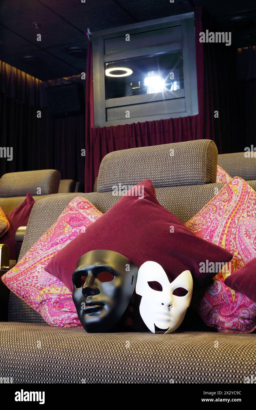 Black and white masks on couch with cushions and projector in movie ...