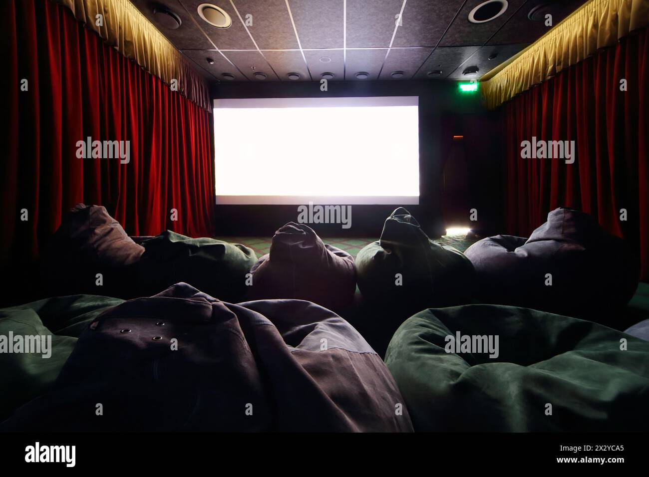 Back of comfortable green unusual seats in movie theater with white ...