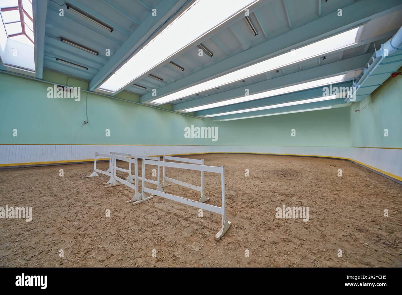 Indoor riding hall with sandy covering Stock Photo - Alamy
