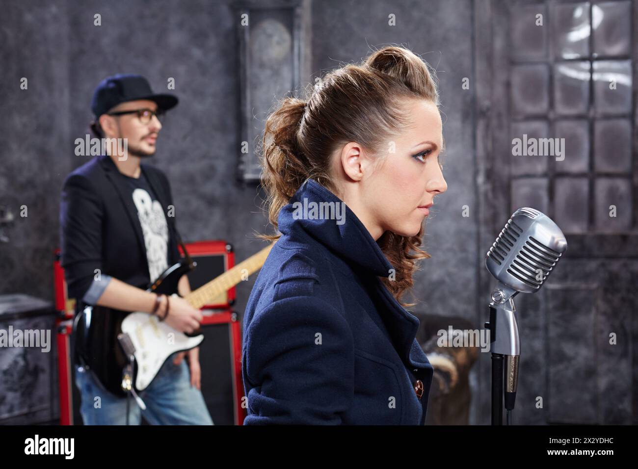 Lead singer stands at microphone in studio Stock Photo - Alamy