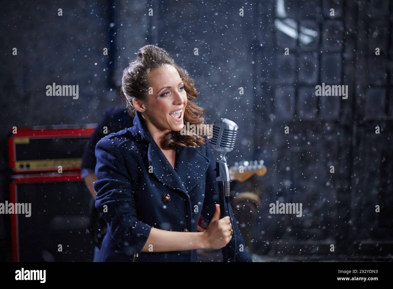 Young woman sings into microphone when shooting musical clip Stock ...