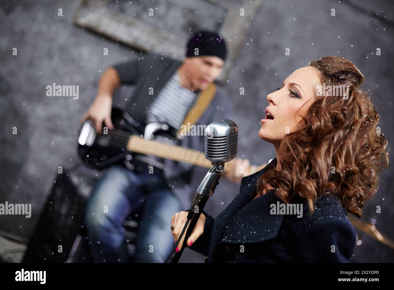 Female lead vocalist and guitarist in studio, turned frame Stock Photo - Alamy