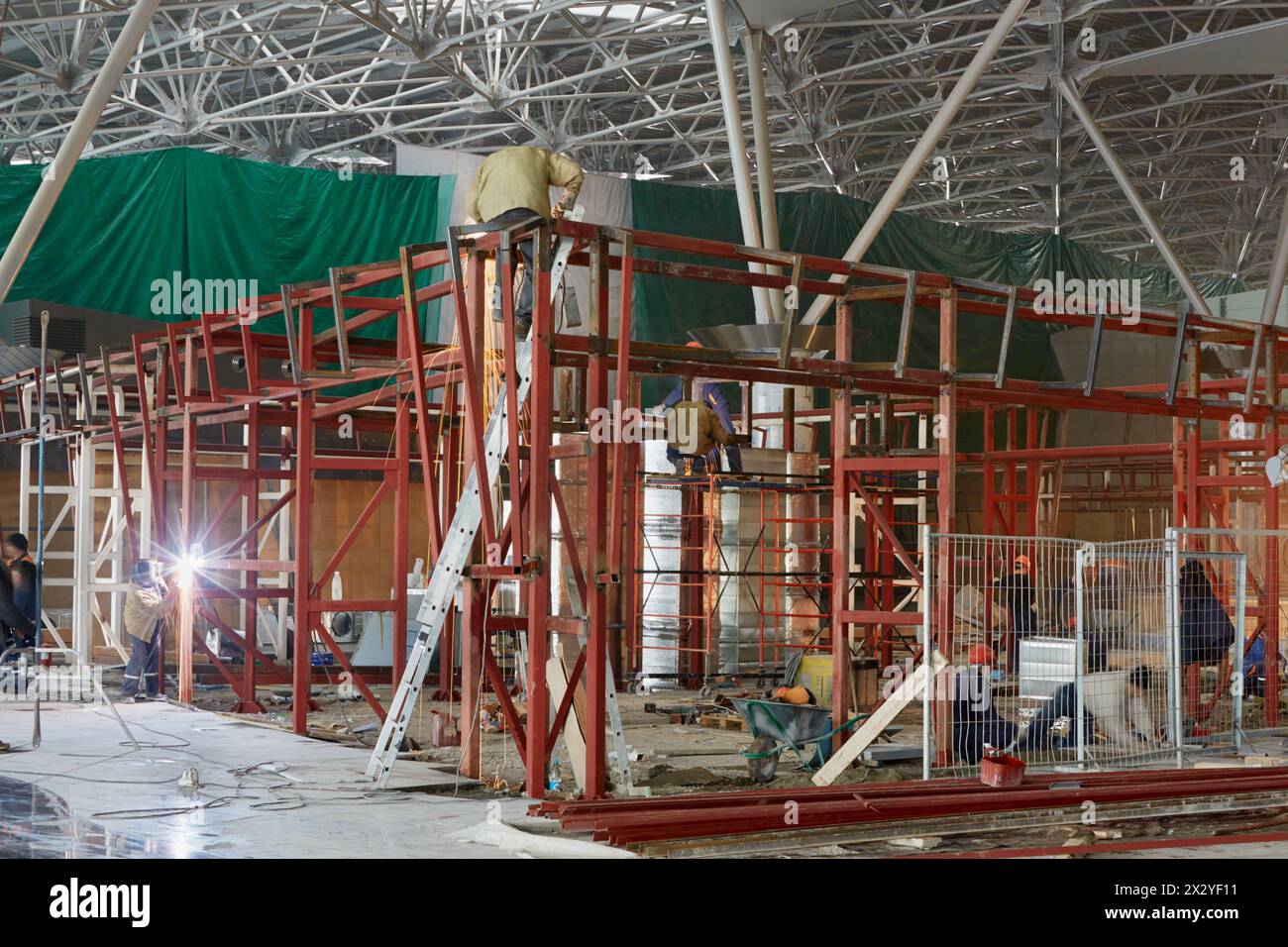 Welders weld steel frame ar construction site Stock Photo - Alamy