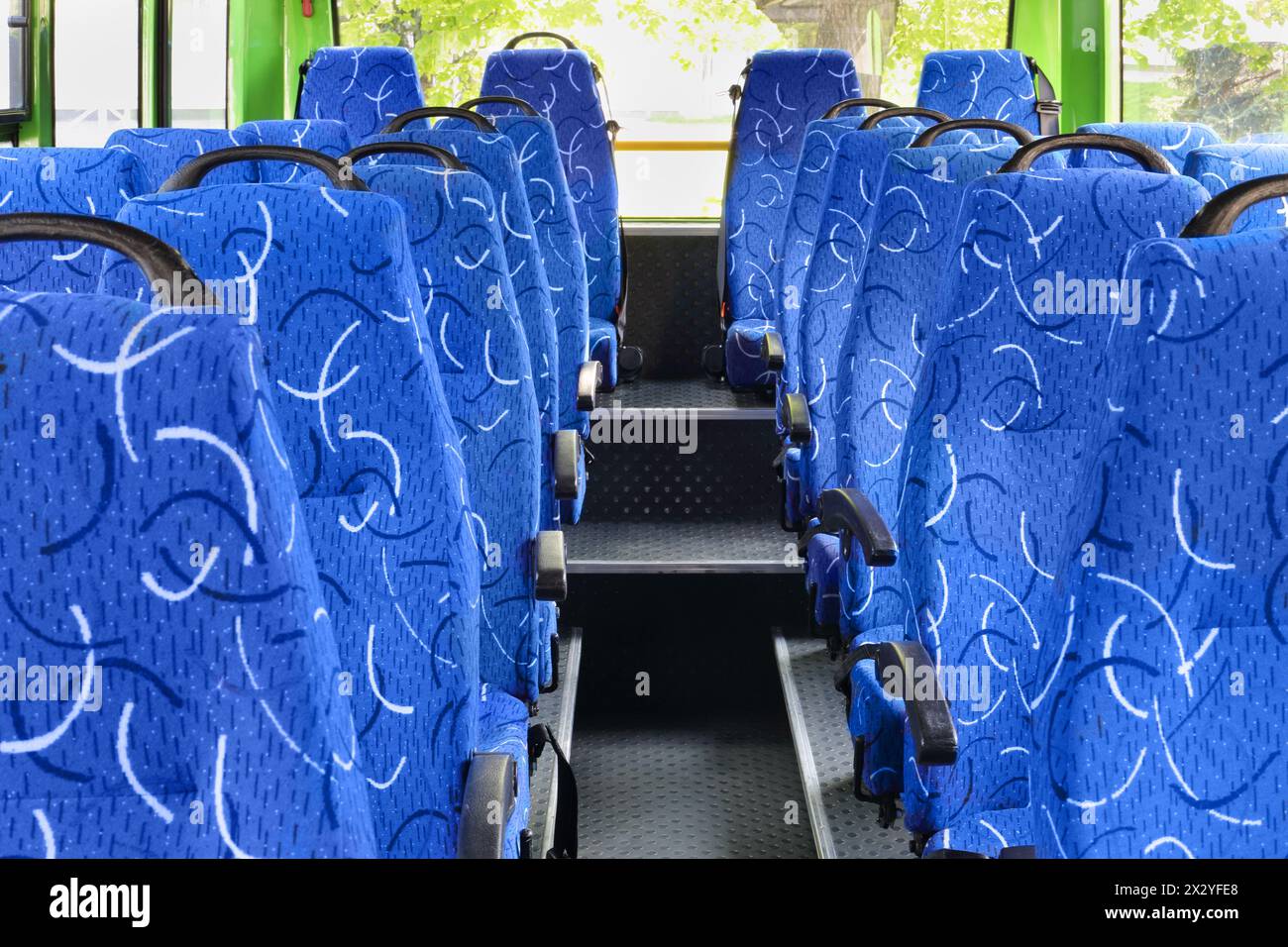Soft seats for passengers inside saloon of empty city bus with grey floor Stock Photo - Alamy