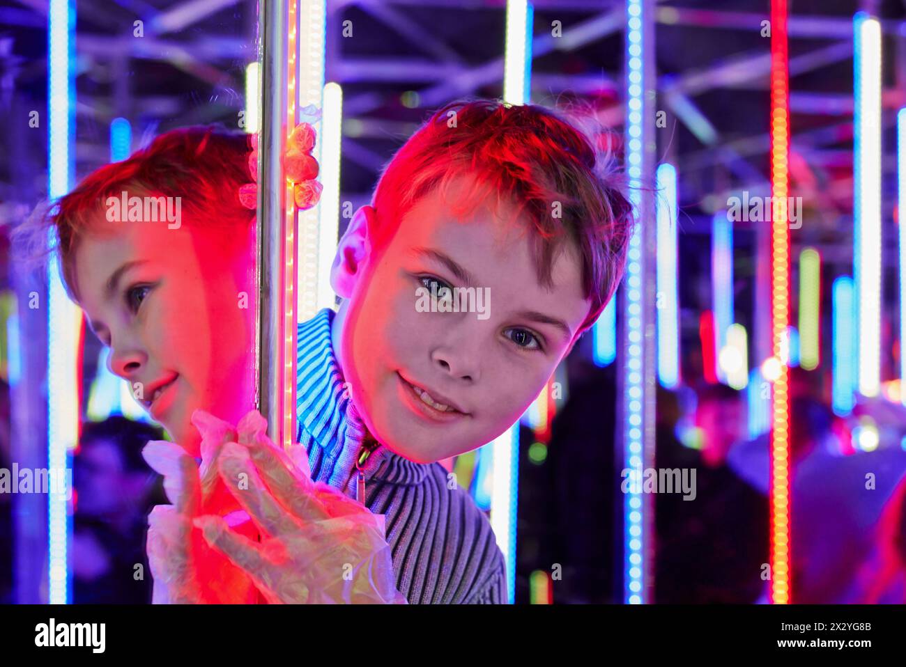 Boy look out from corner in mirror labyrinth Stock Photo - Alamy