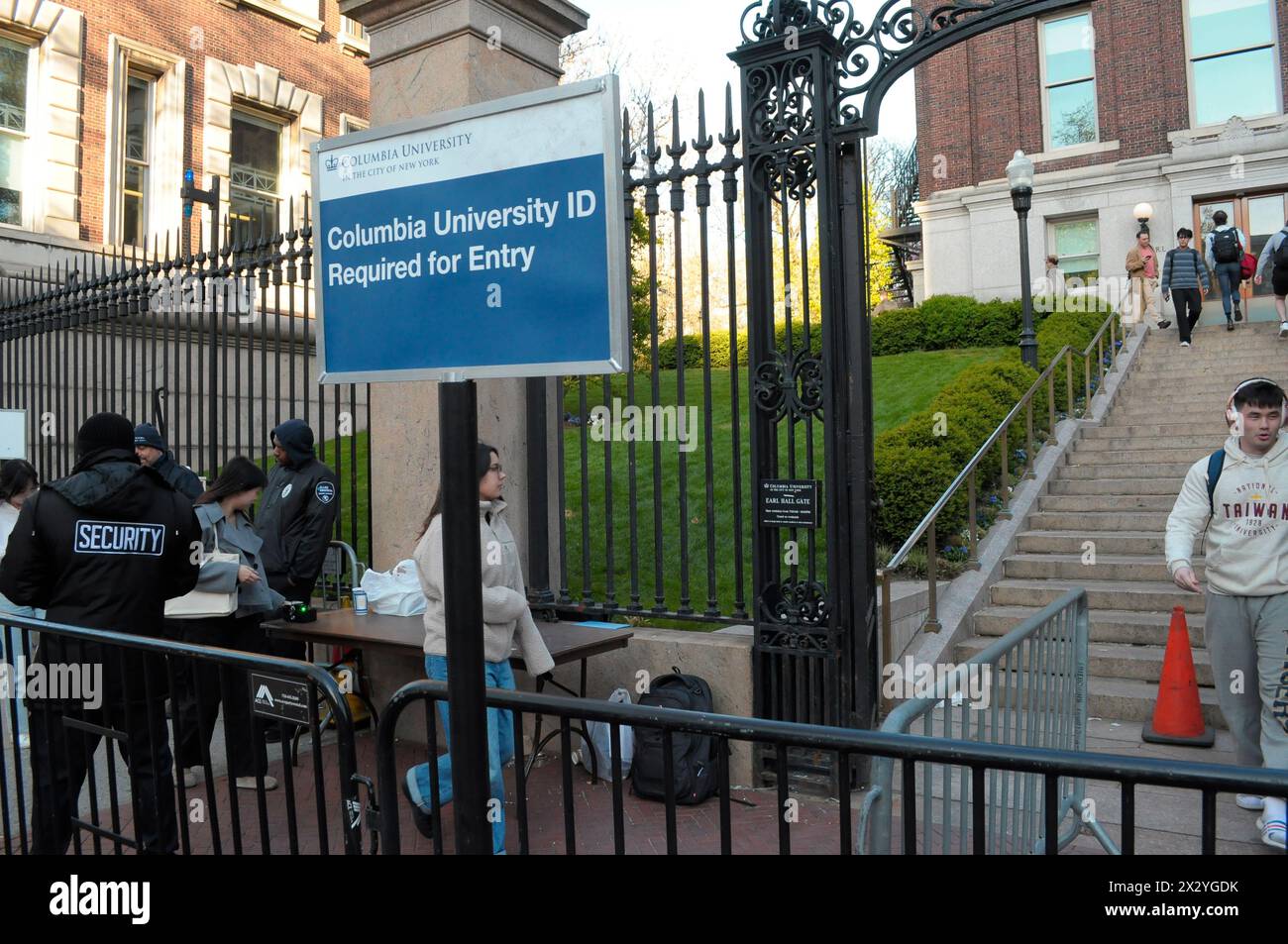 People scan their university IDs to enter an entrance at Columbia ...