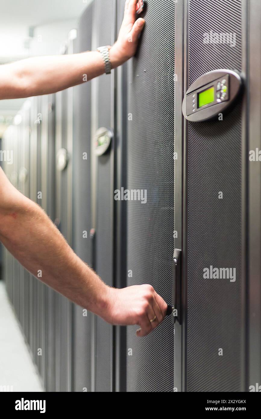 Man opens telecommunication racks Stock Photo - Alamy
