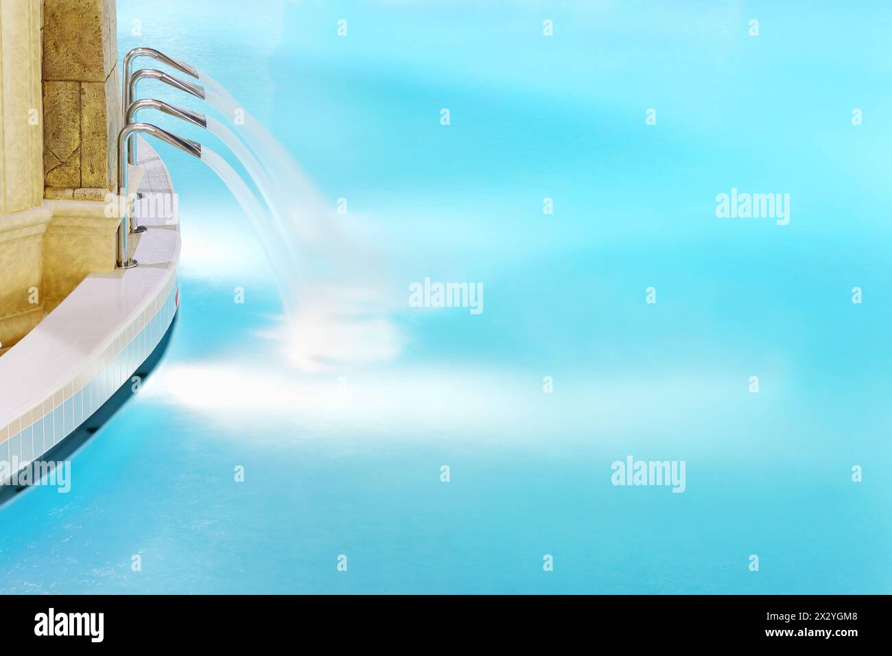 Four water jets in pool with pure blue water with illumination Stock ...