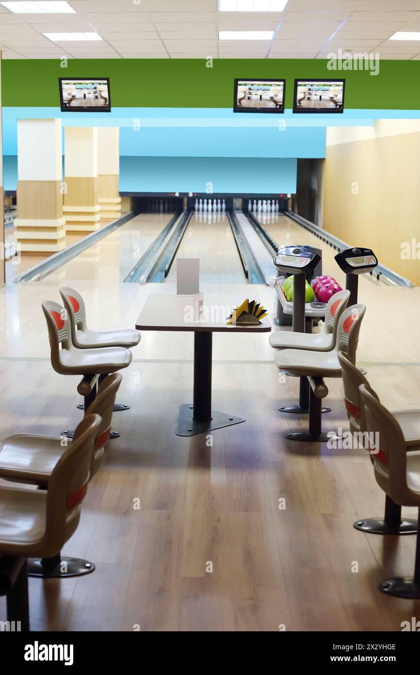 Small light bowling club with wooden floor, table and chairs Stock ...