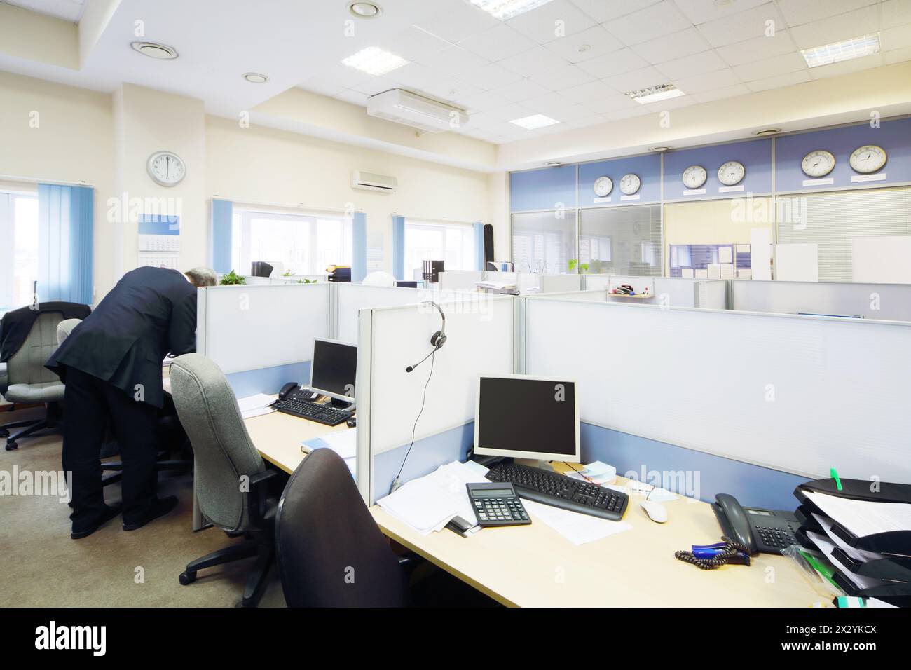 People work in big light office with separated by partition places of ...