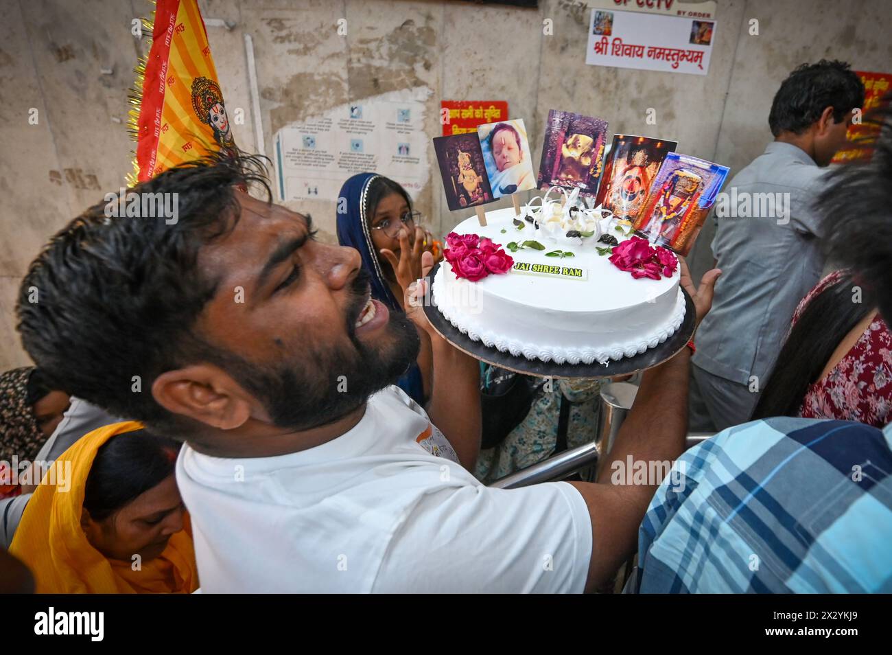 NEW DELHI, INDIA - APRIL 23: A devotee seen carrying a birthday cake on ...