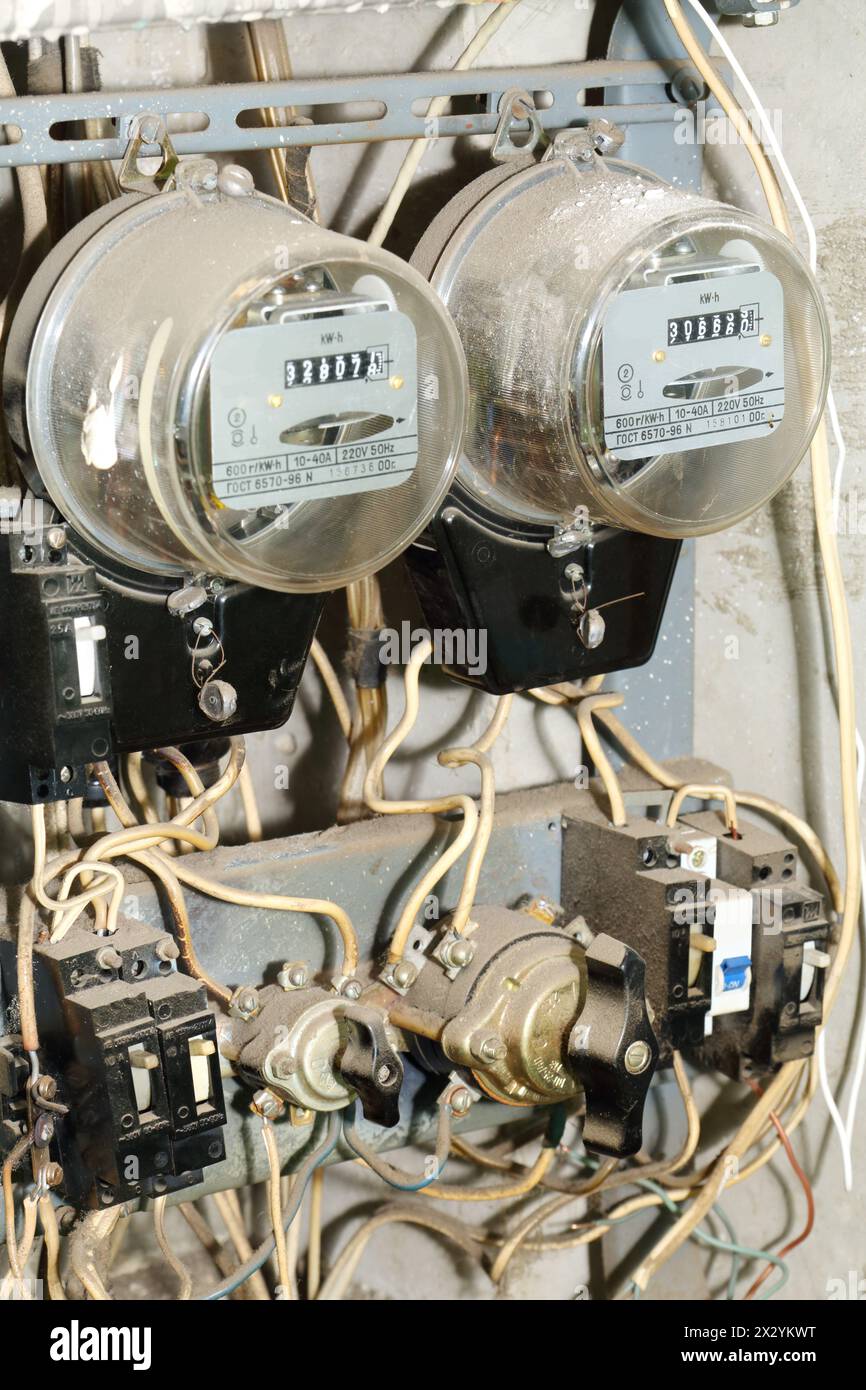 Two old, dirty meters for electricity with lot of wires, switches and ...