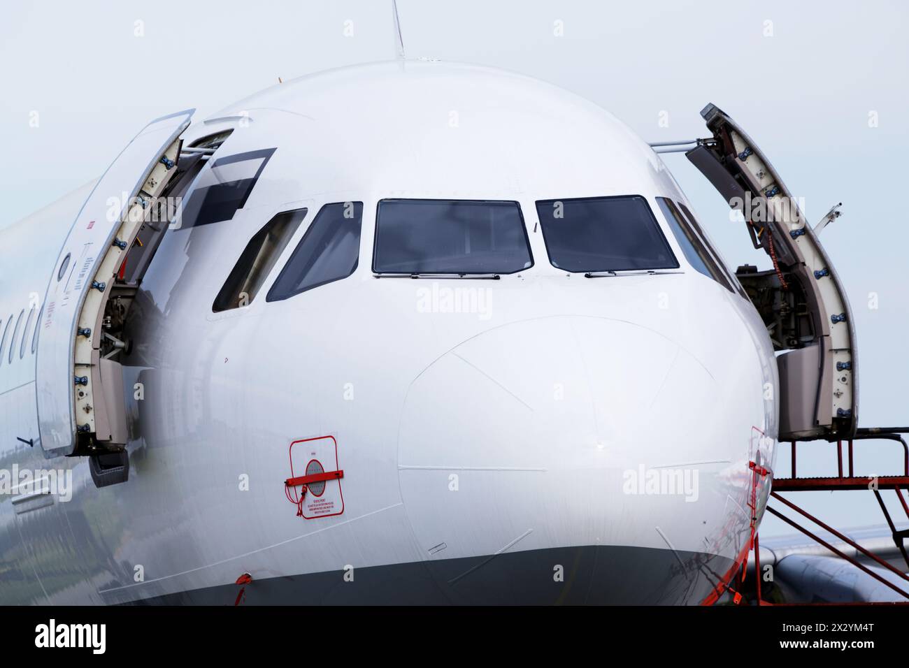 Nose and cockpit of airplane at airport close up Stock Photo - Alamy