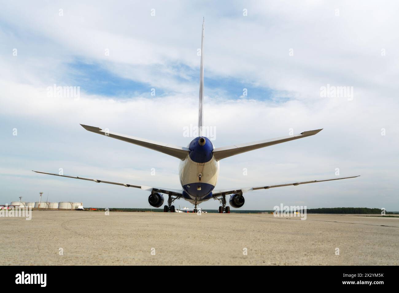 Rear view of airplane standing on runway at aerodrome Stock Photo - Alamy